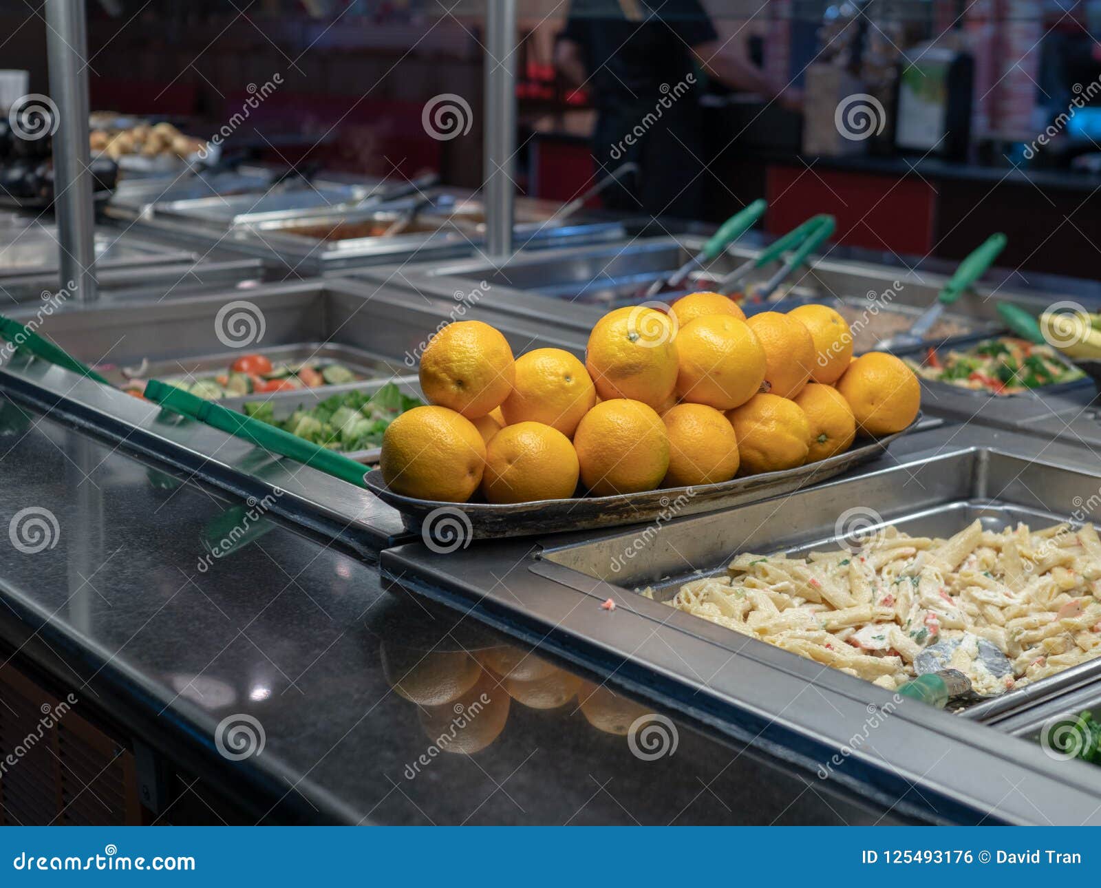 Oranges Piled on a Buffet Table with Various Pastas Stock Photo - Image ...