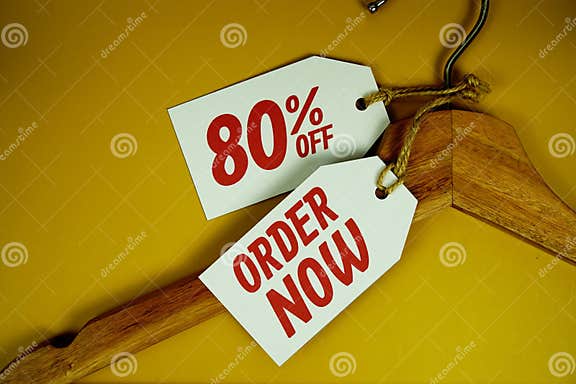Order Now and Sale 80 on Price Tag with Wooden Clothes Hanger on Yellow ...