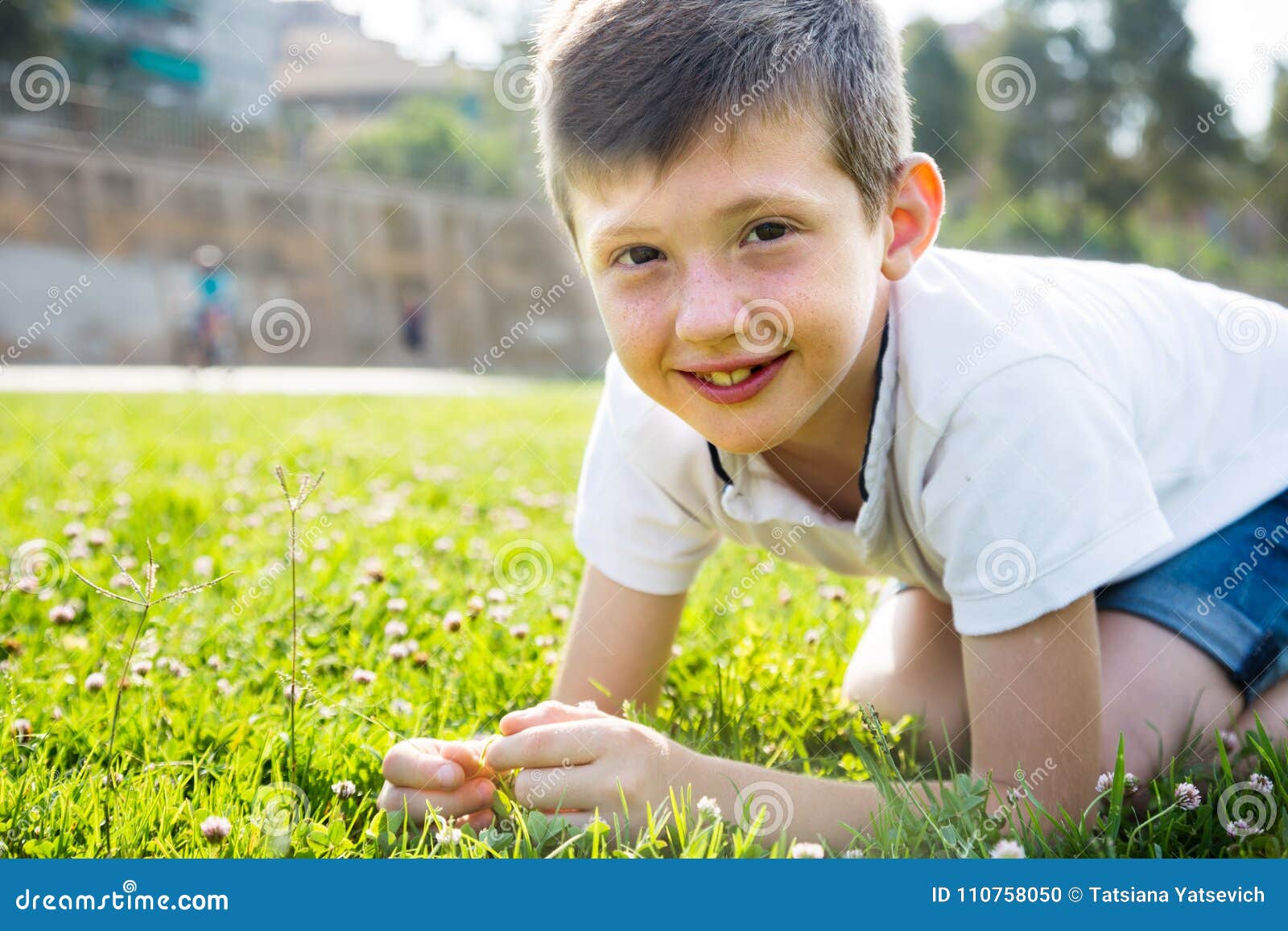Boy sitting grass stock photo. Image of beautiful, positive - 110758050