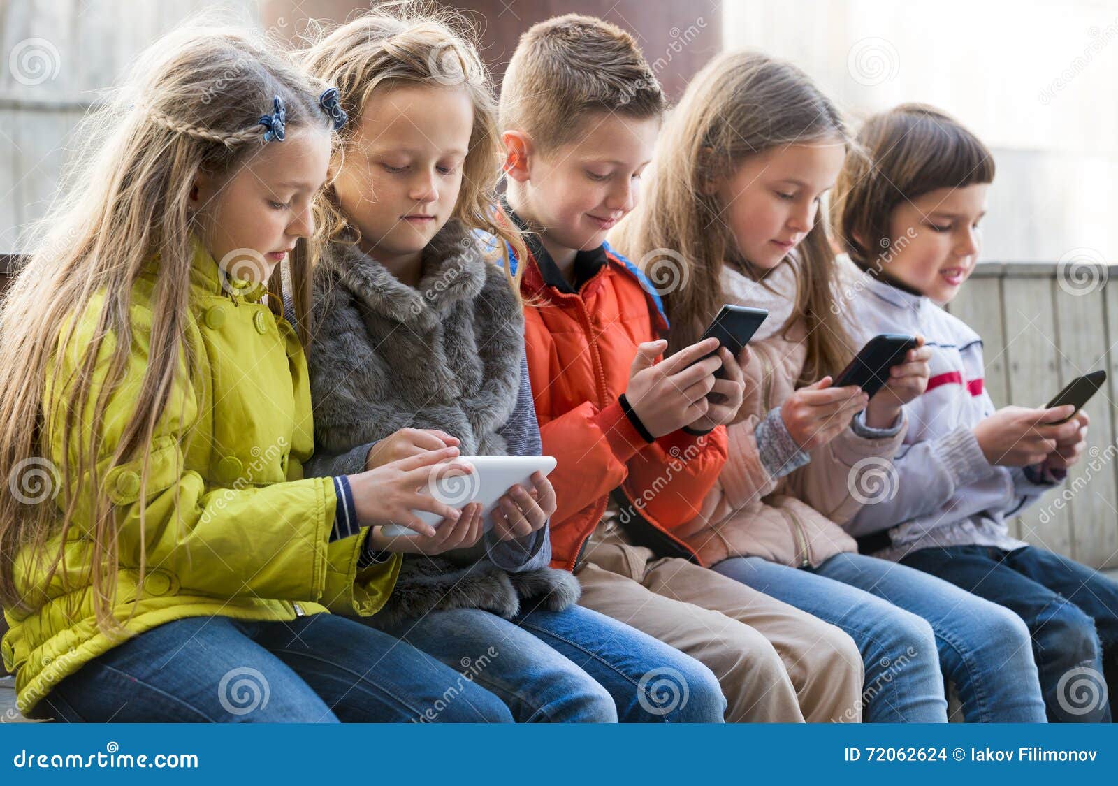 Ordinary Kids Sitting with Mobile Devices Stock Photo - Image of phone ...