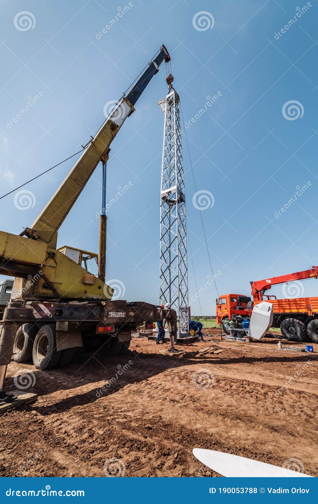 Workers Using Construction Equipment Install a Wind Generator Editorial ...