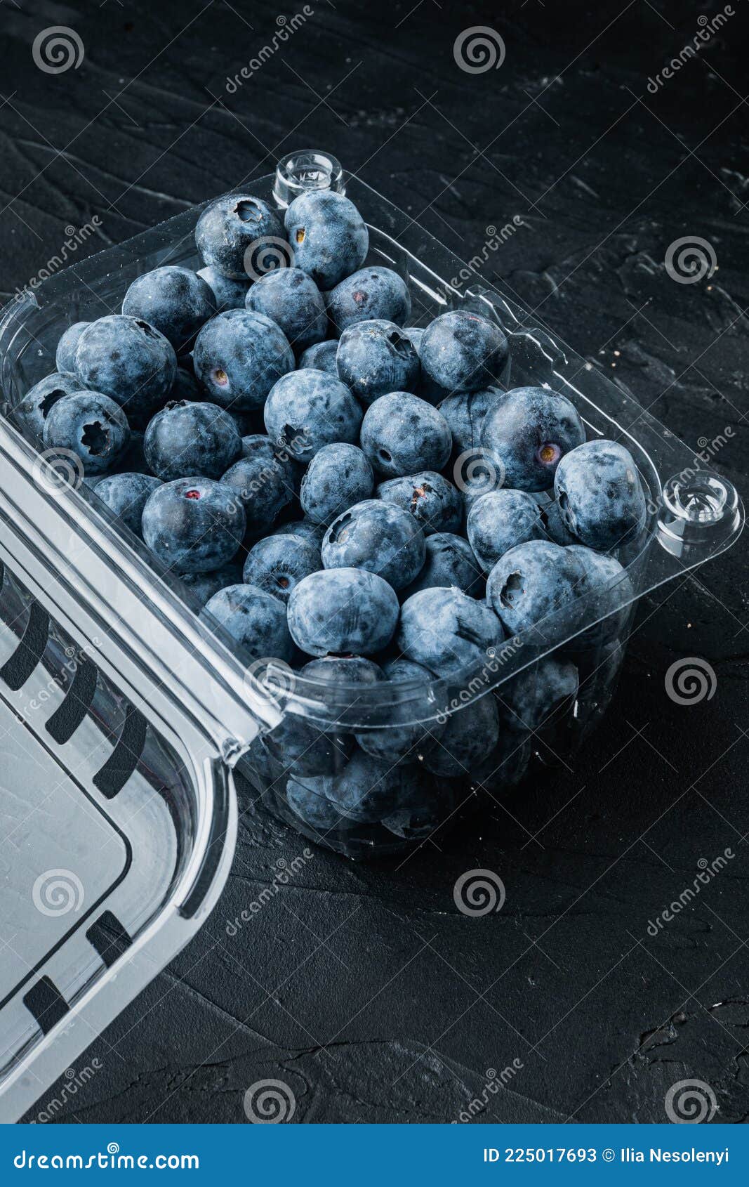 Organic Blueberries in Plastic Box Package, on Black Background Stock ...