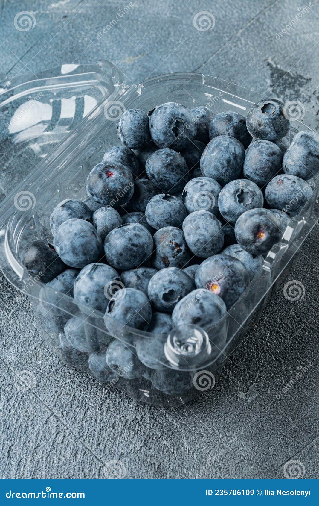 Organic Blueberries in Plastic Box Package, on Gray Background Stock ...