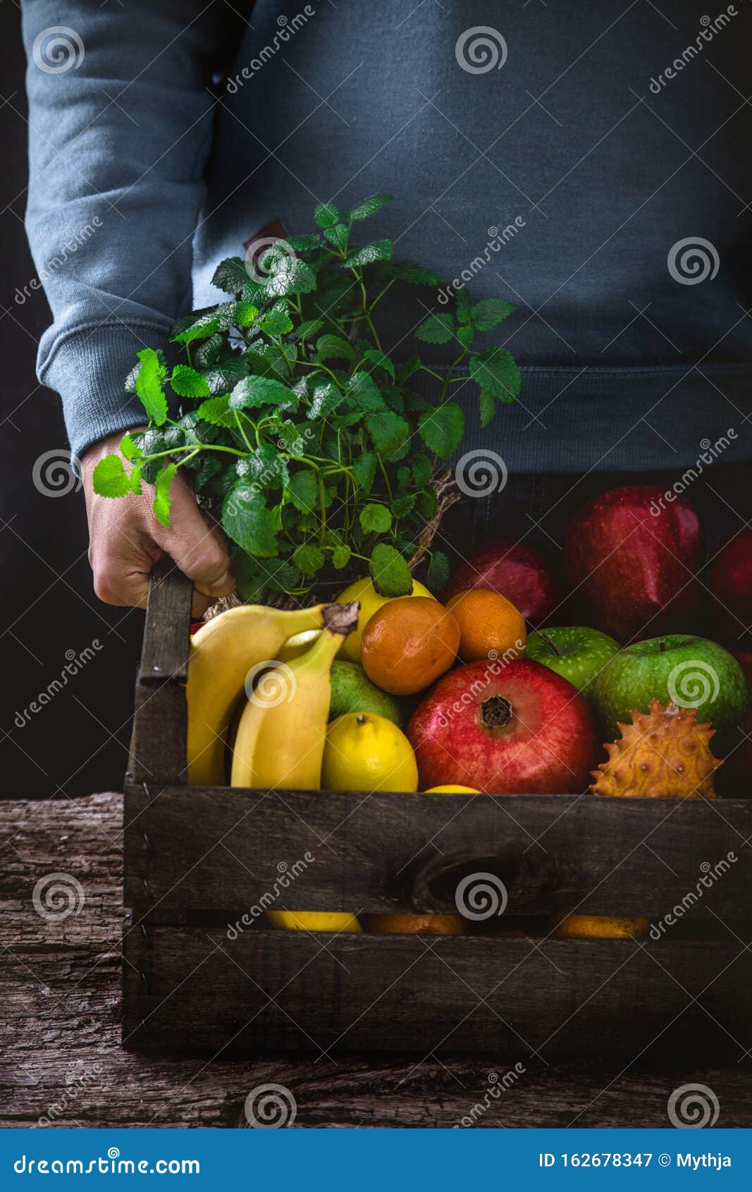 Organic fruit on wood stock image. Image of fruit, holding - 162678347