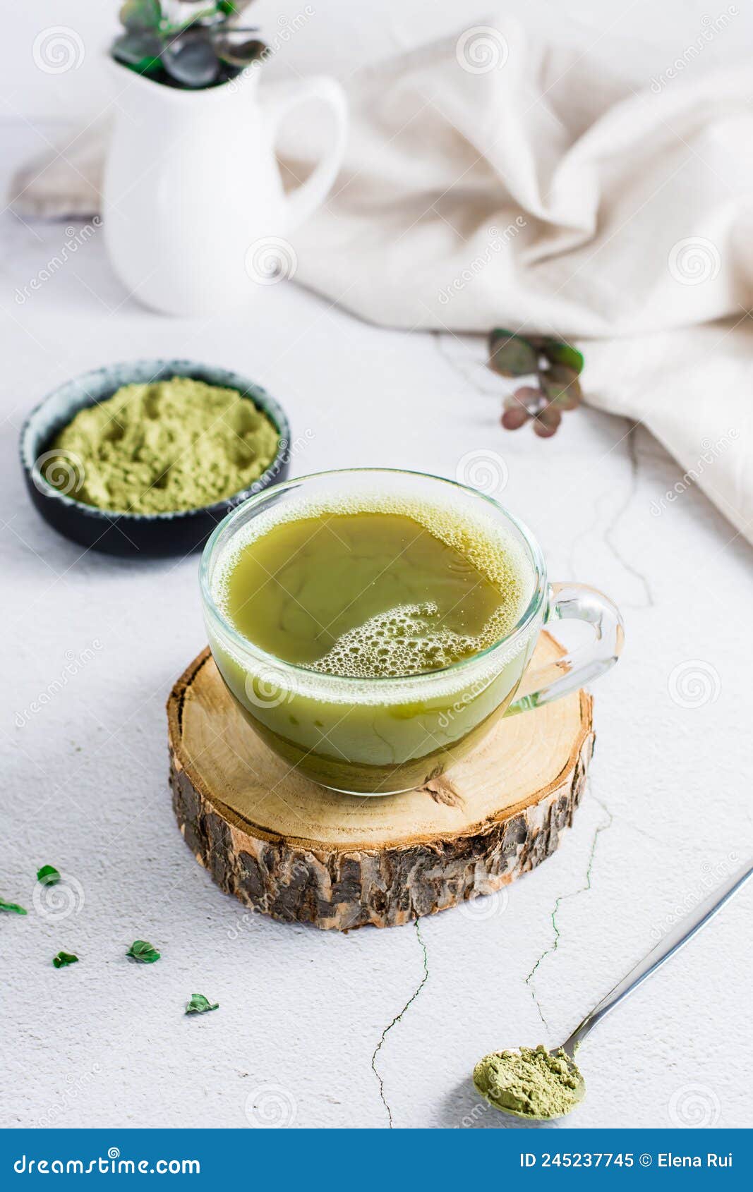 Organic Green Matcha Tea in a Cup on a Tree Trunk on the Table ...