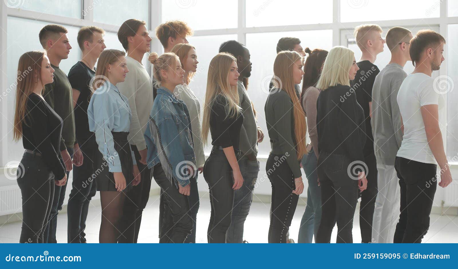 Organized Group of Casual Young People Standing in a Column Stock Image ...