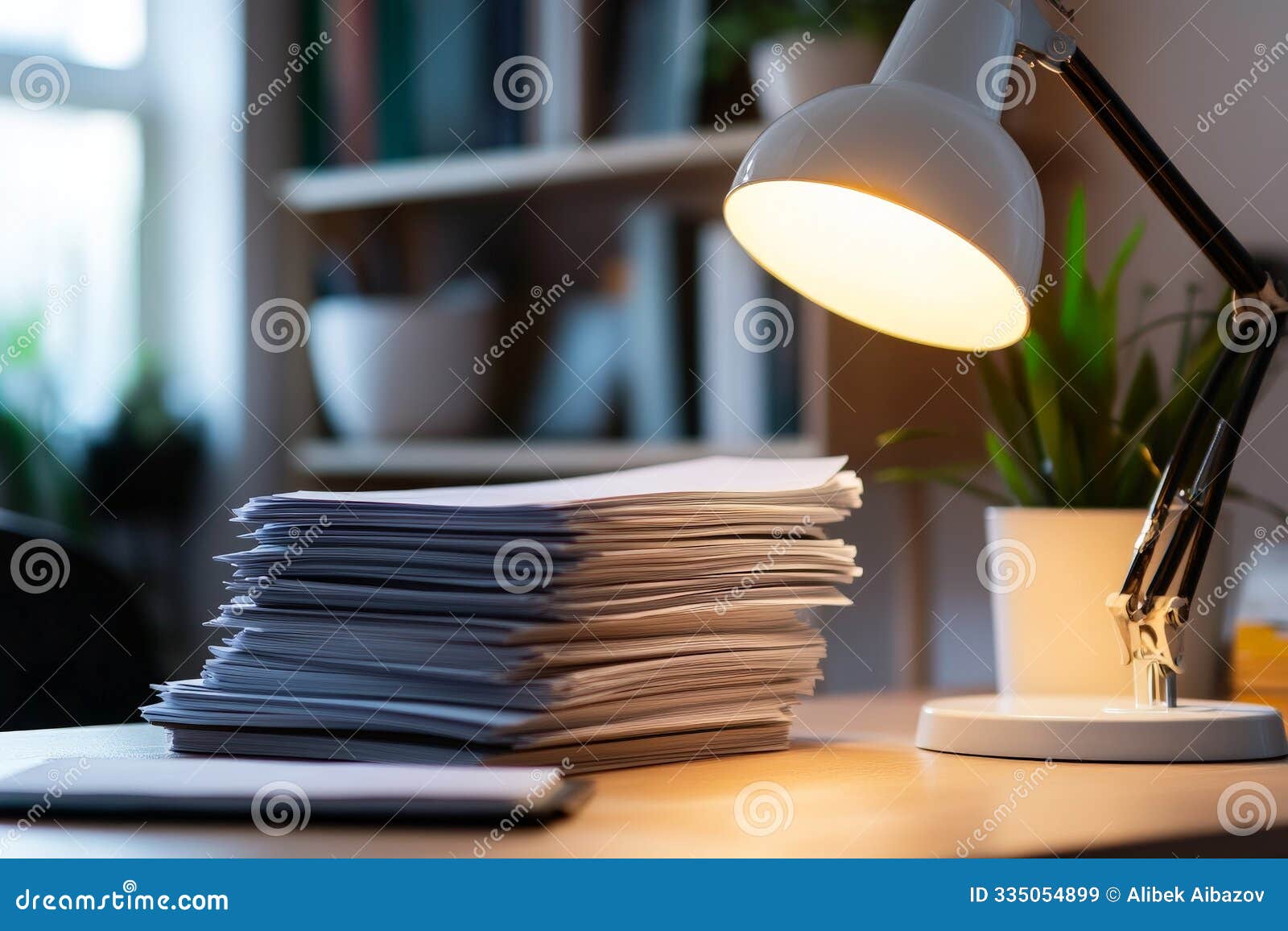 Organized Workspace with Stacked Documents Under Lamp Light in a Modern ...