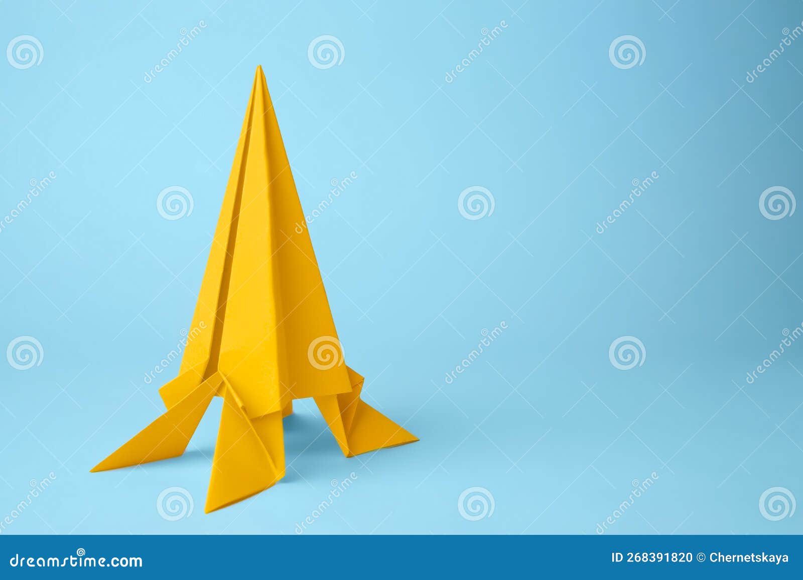 Origami Art. Handmade Yellow Paper Rocket on Light Blue Background ...