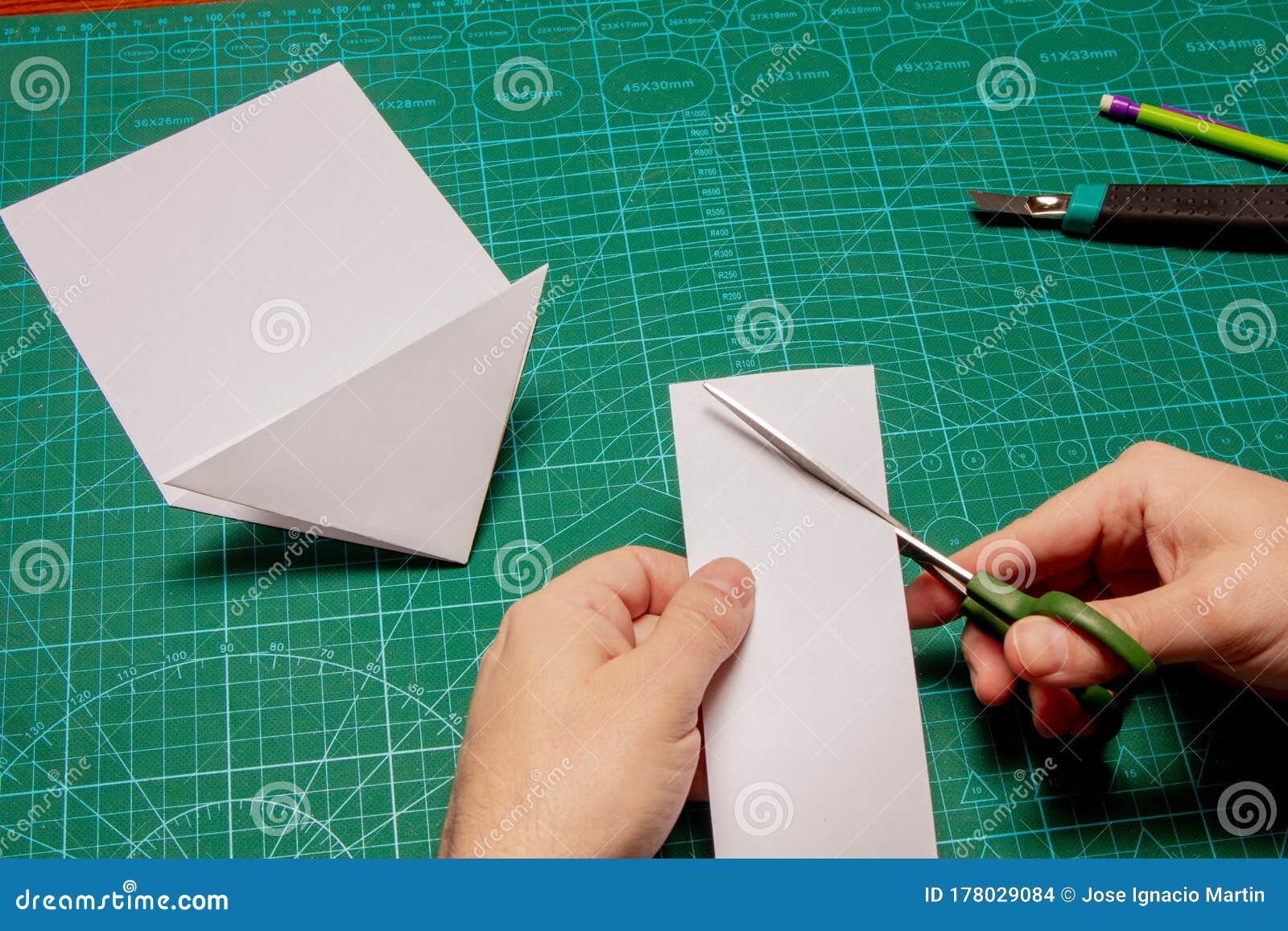 Origami Project On White Paper With Cutter And Scissors Stock Photo ...