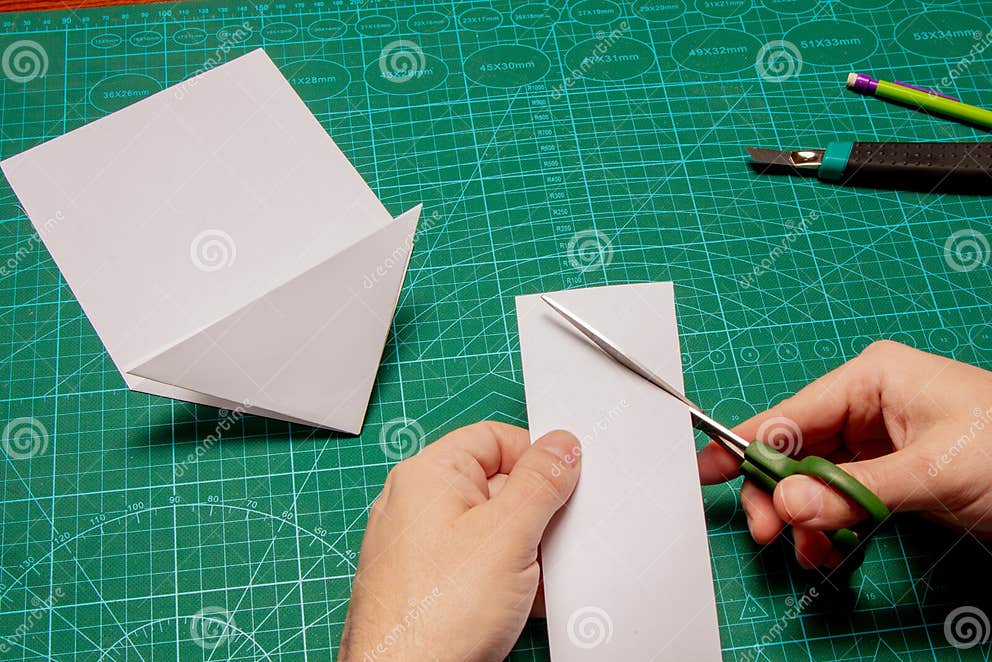 Origami Project on White Paper with Cutter and Scissors Stock Photo ...