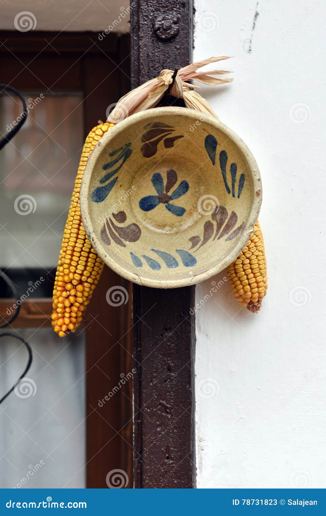 Ornamental Rustic Ceramic Plate and Corn Hanging on a Wall Stock Image ...