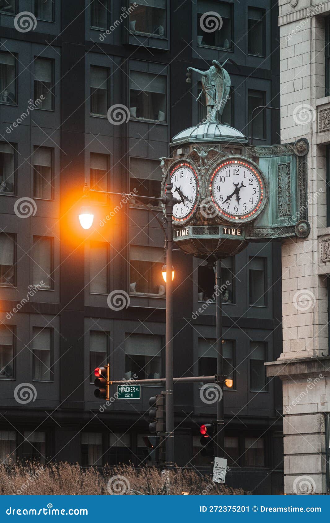 Ornate Clock and Statue are Prominently Displayed in Front of a Stately ...
