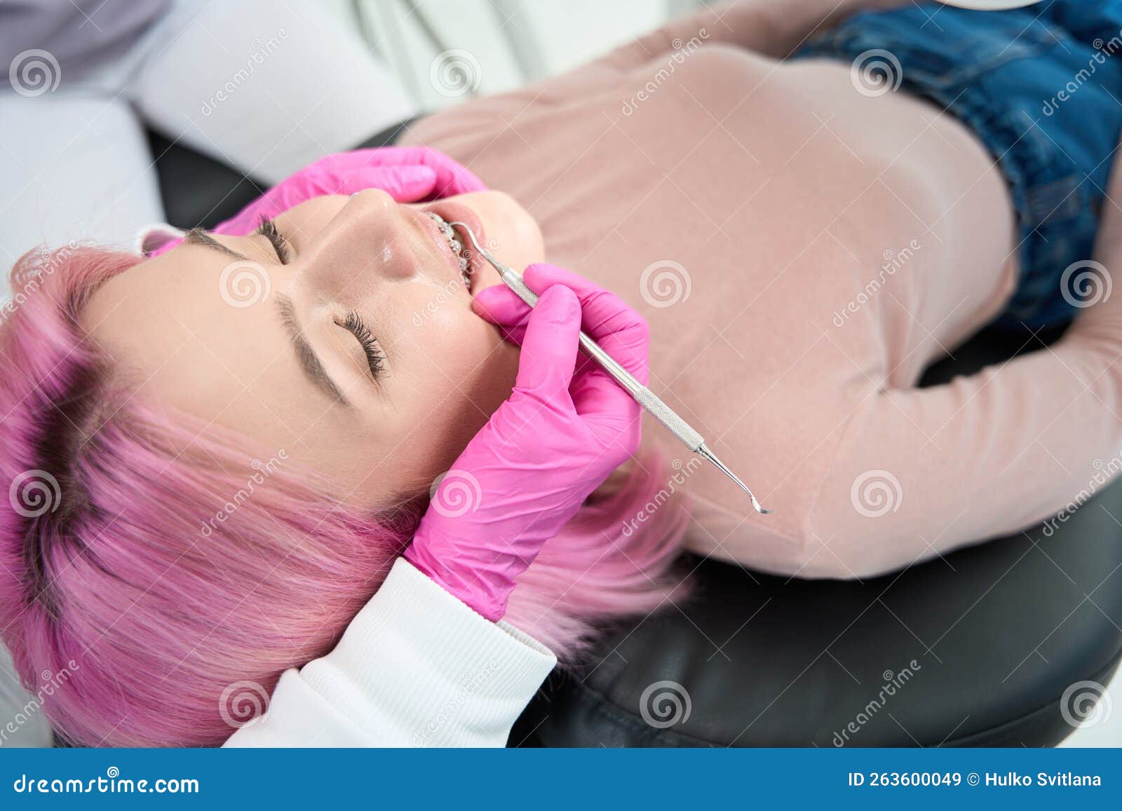 Orthodontist Performs Maintenance of a Bracket System for Teeth ...