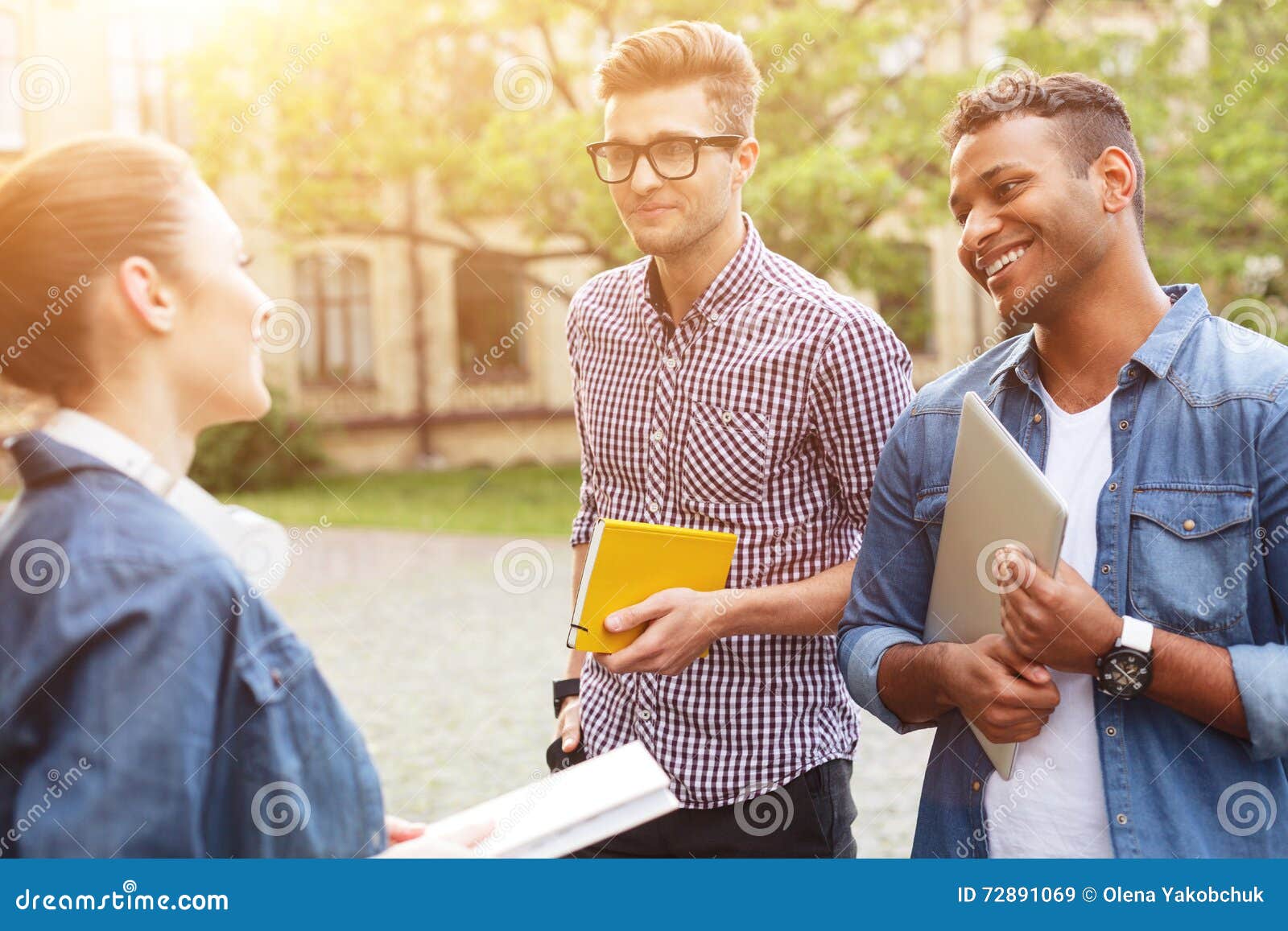 Os Três Estudantes Alegres Estão Conversando No Terreno Imagem de Stock ...