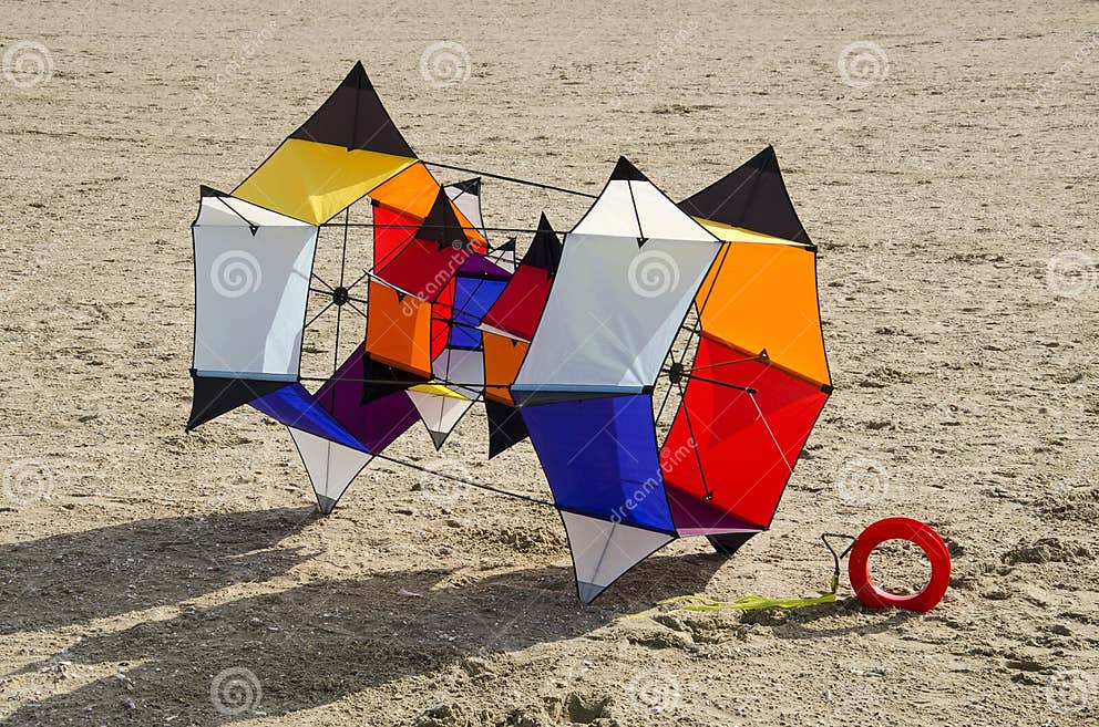 Colorful kite in the sand editorial stock photo. Image of shore - 147593603