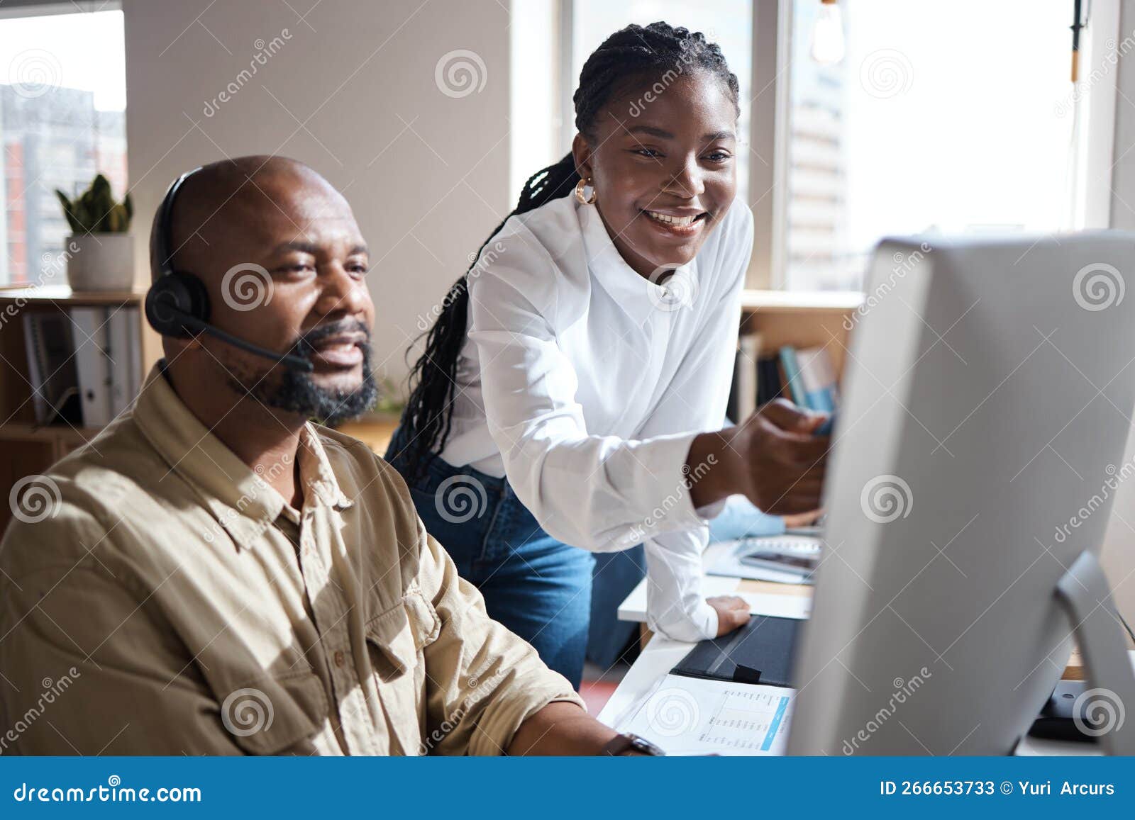 Our Customers are Our Backbone. a Businessman and Businesswoman Using a Headset and Computer ...