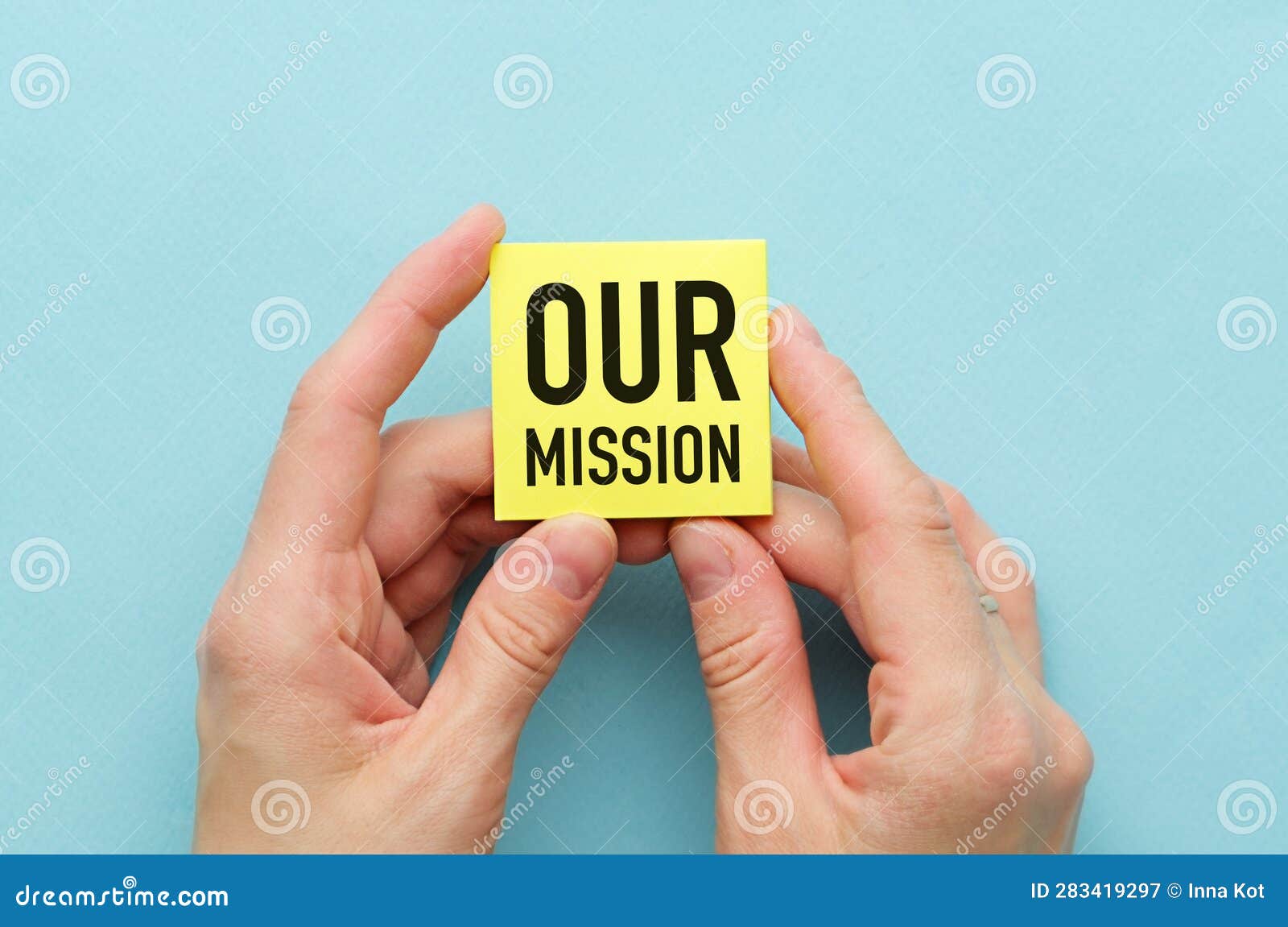 OUR MISSION Text Written on Sticky in Hands on Blue Background Stock ...