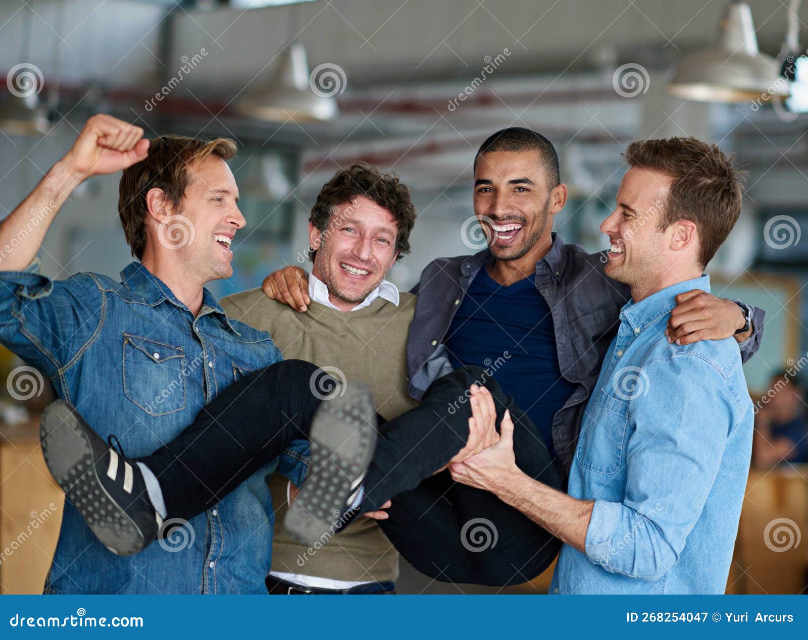 Our Office Hero Male Colleagues Lifting Up A Coworker In Victory And
