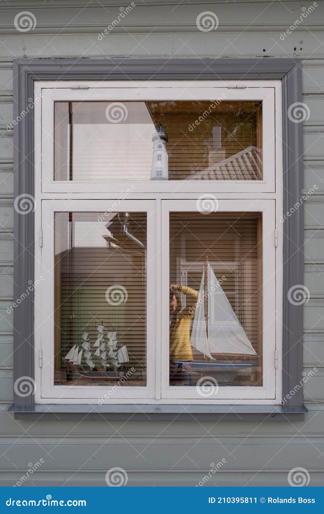 Ouse Has a White Window and a Decorative Sailing Ship Standing in the ...