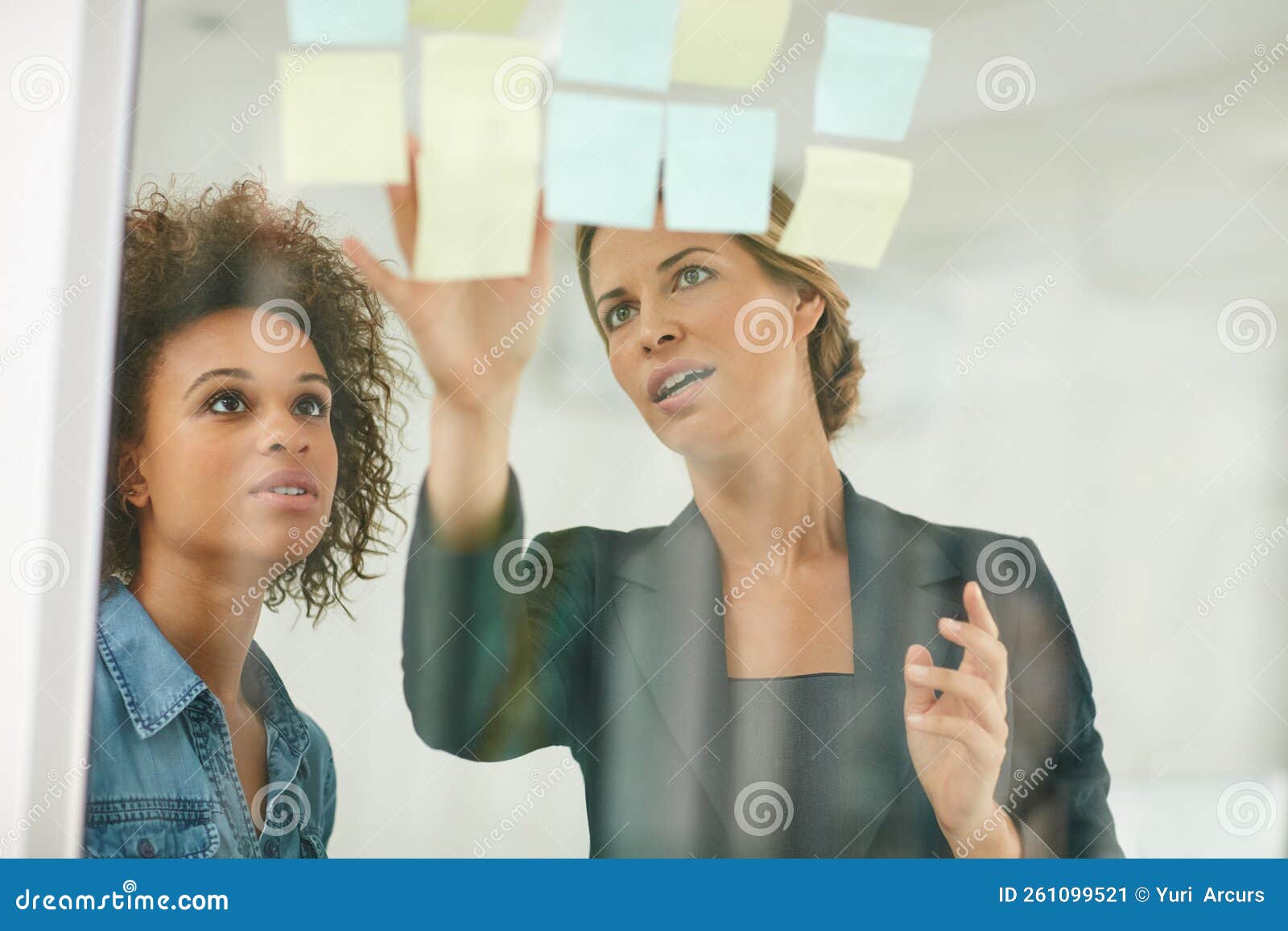 Out of Commitment Comes Determination. Coworkers Using Sticky Notes ...