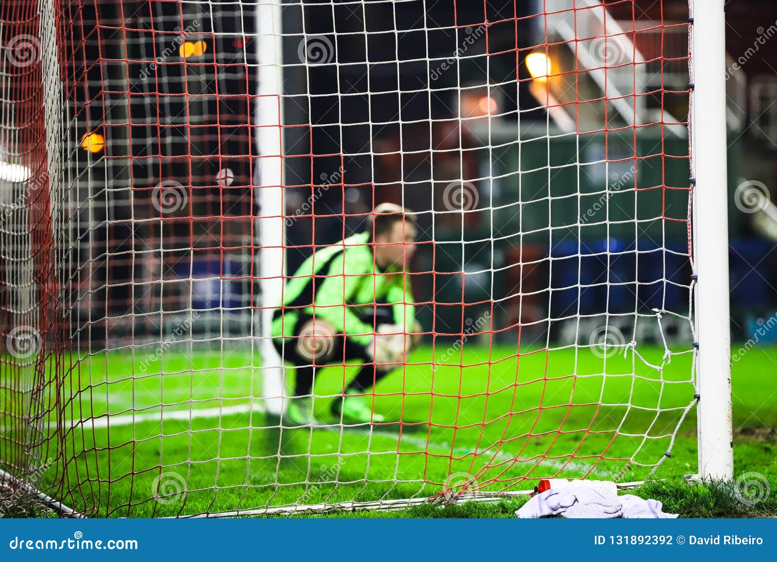Out of Focus Goalkeeper Crouching Down Near the Goal Post Stock Photo ...