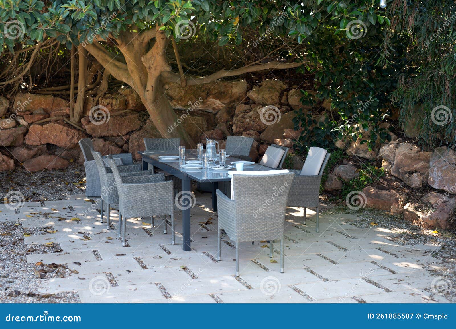 Outdoor Dining Area Under the Shelter of a Large Tree Stock Image ...