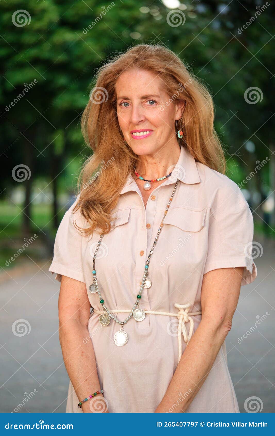 Outdoor Portrait Of Smiling Mature Blonde And Blue Eyed Woman Stock