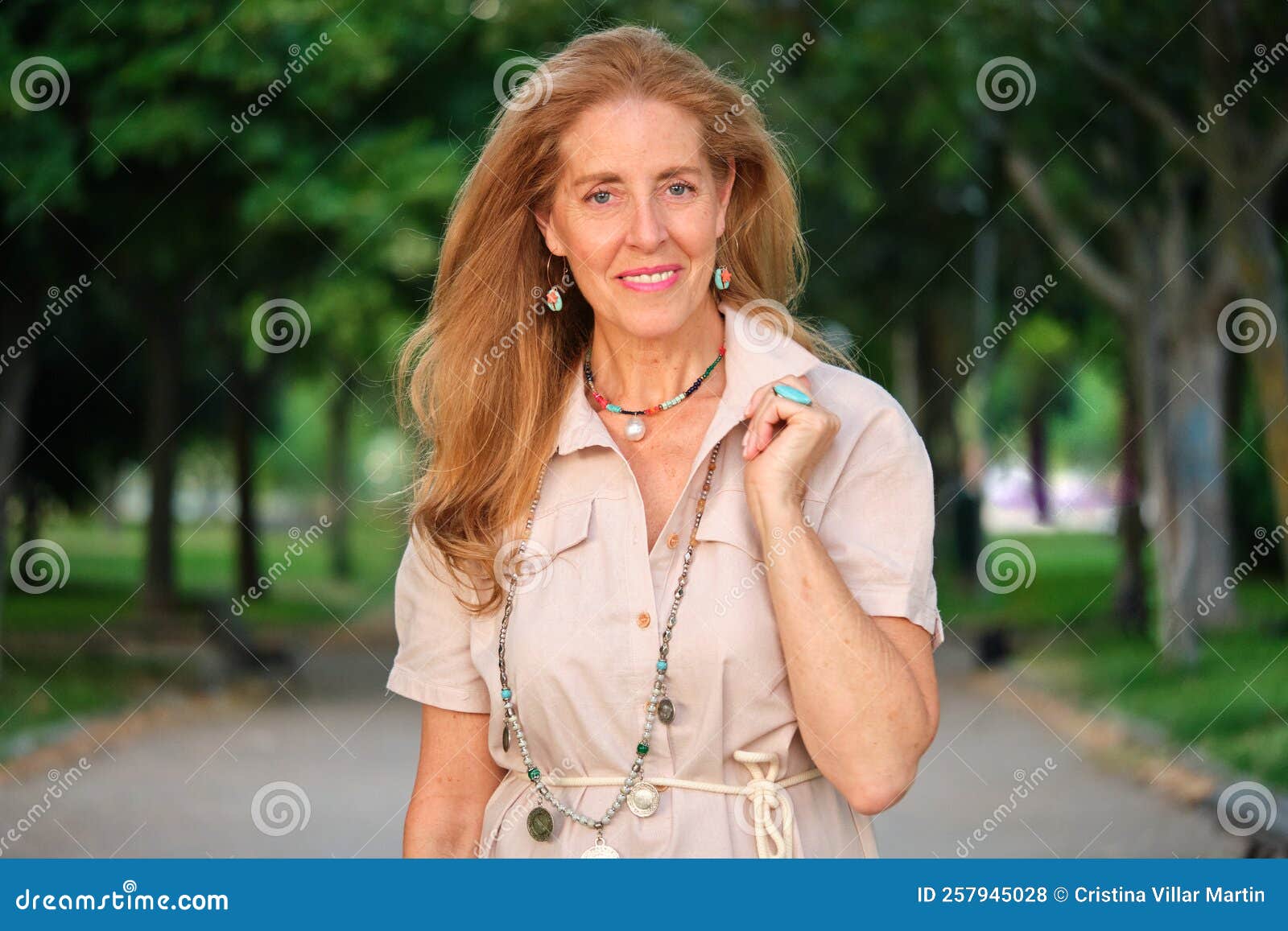 Outdoor Portrait Of Smiling Mature Blonde And Blue Eyed Woman Stock