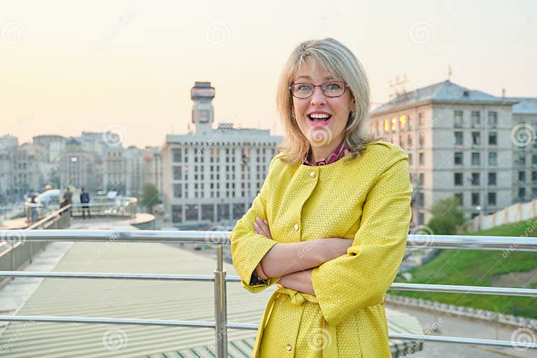 Outdoor Portrait Of Smiling Mature Woman With Folded Hands Stock Image