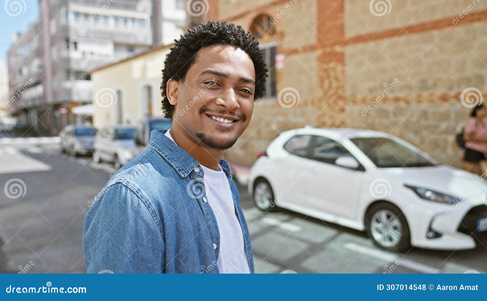 Outdoor Portrait of a Smiling Young Adult Man with Curly Hair in a City ... Outdoor Portrait of a Smiling Young Adult Man with Curly Hair in a City ...