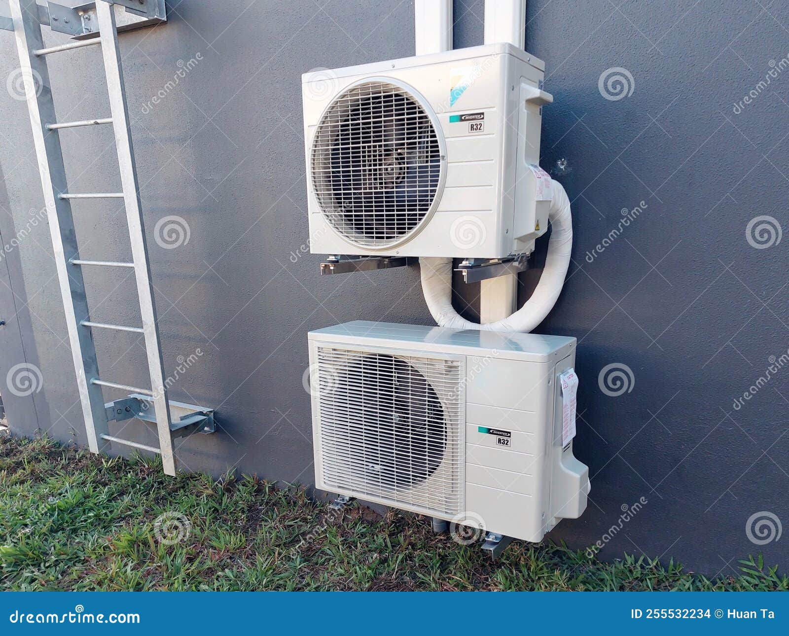 An Outdoor Wall Mounted Condenser Unit Near a Ladder Stock Photo ...