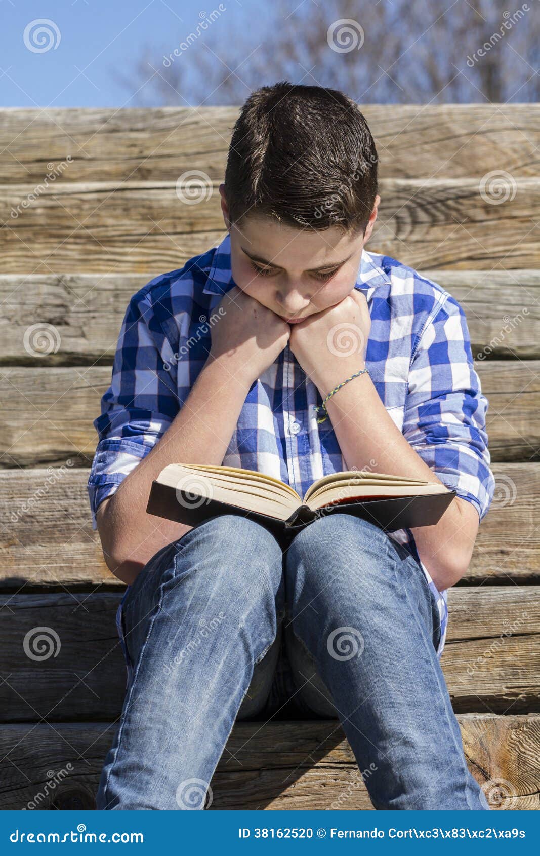 Outdoor.Young Boy Reading a Book in the Woods with Shallow Depth Stock ...