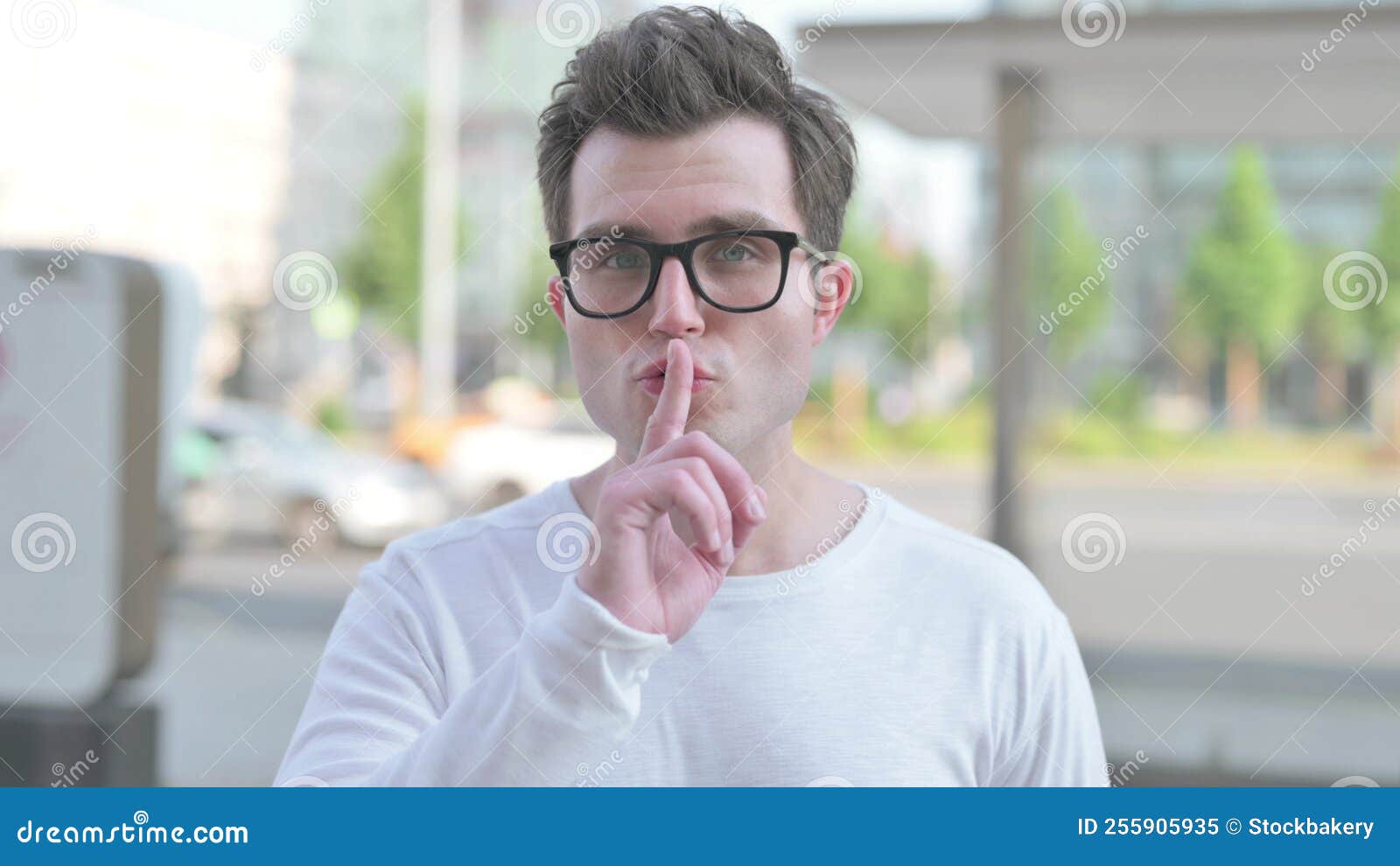 Outdoor Young Man with Finger on Lips, Please Be Quiet Stock Image ...