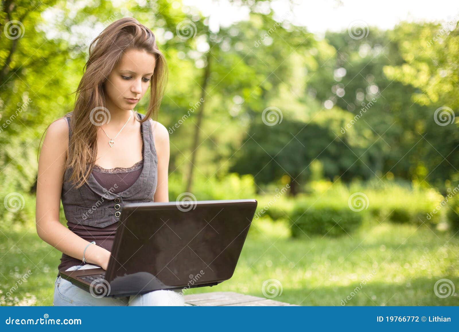 Outdoors with her laptop. stock photo. Image of portrait - 19766772
