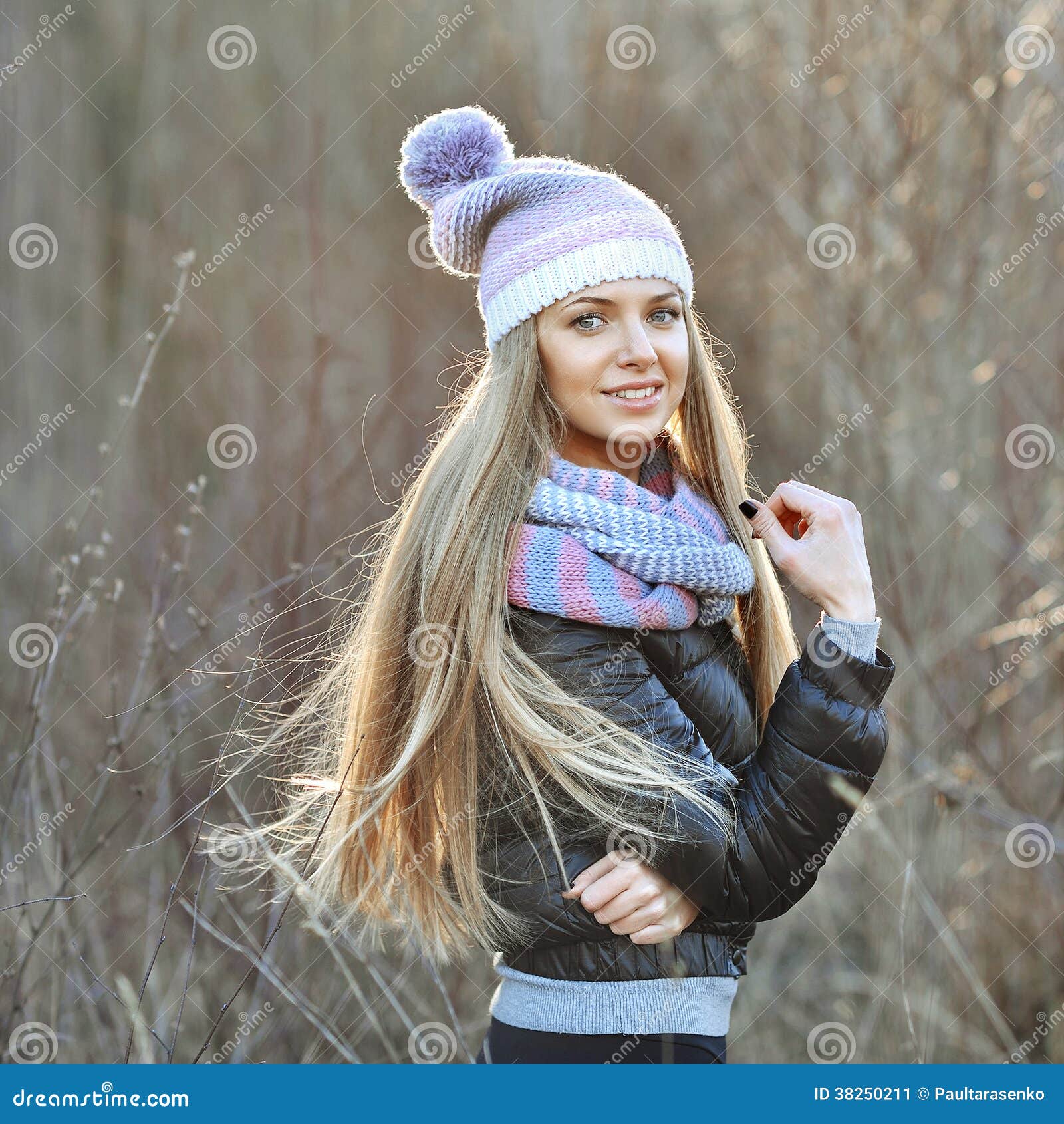 Outdoors Portrait Of Blonde Girl In Knitted Clothes Smiling Stock