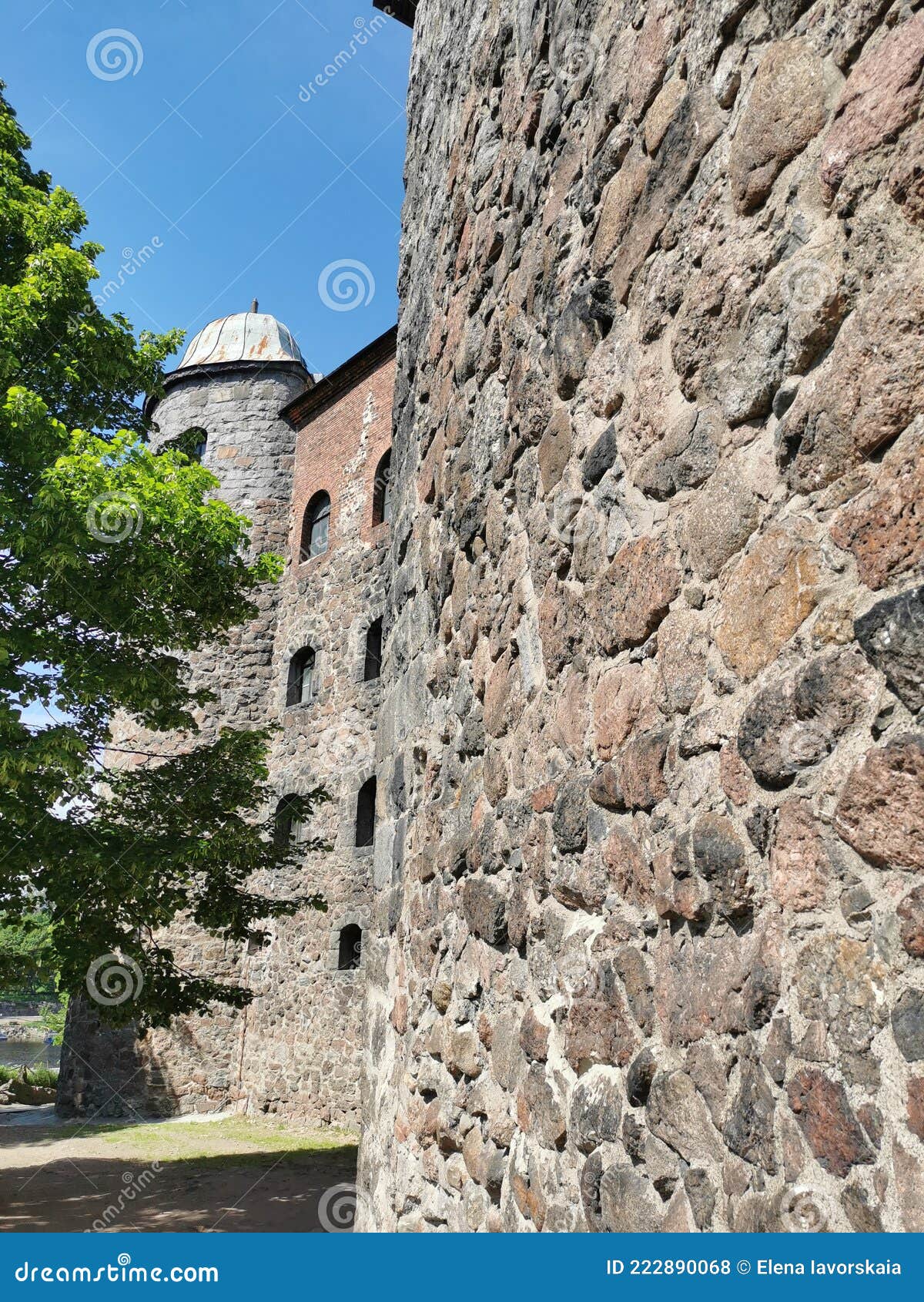 The Outer Stone Wall and the Round Tower of the Vyborg Castle in the City of Vyborg Against the ...