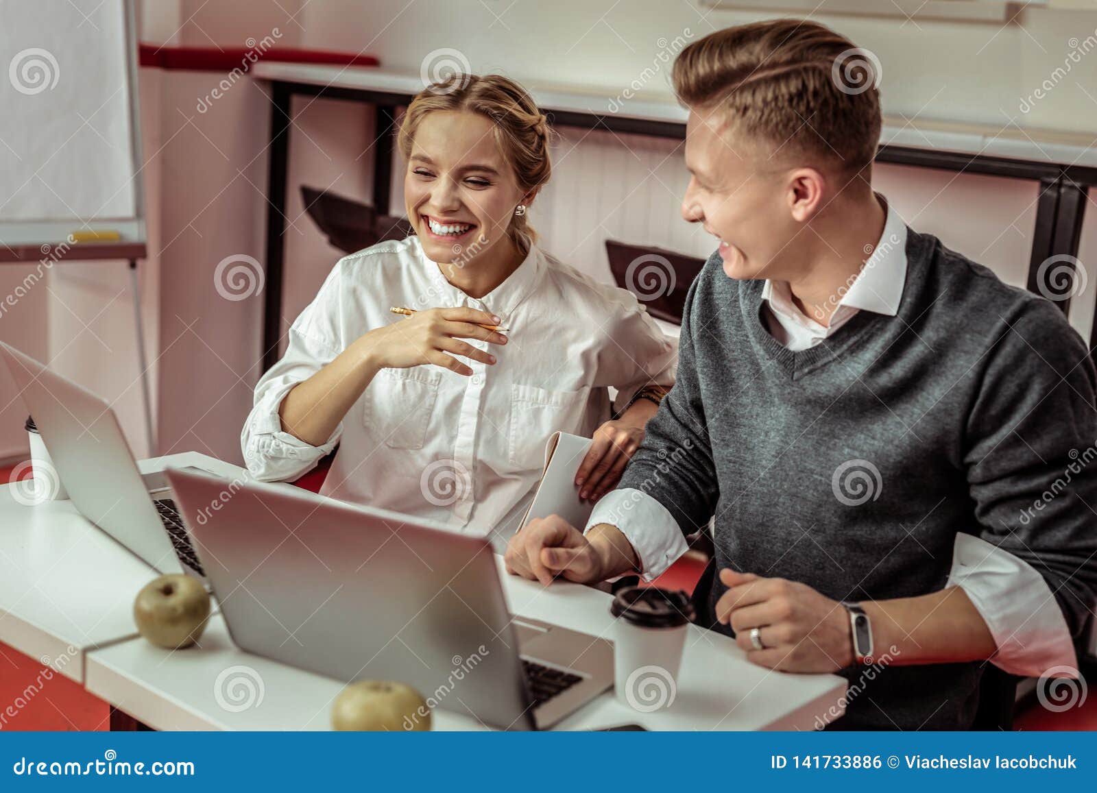 Outgoing Co-workers Being in Great Mood at Work while Laughing Stock ...