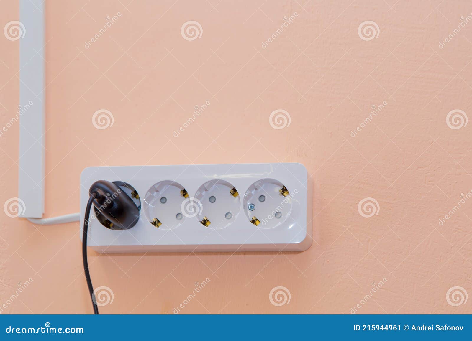 An Outlet with a Plugged-in Plug and Wires Going Side by Side in a Box ...