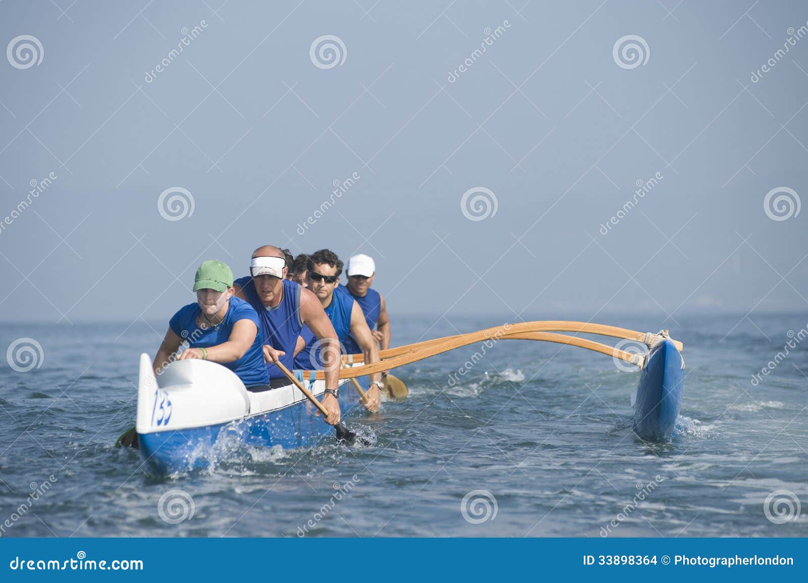 Outrigger Canoeing Team in Race Stock Photo - Image of paddling, latin ...