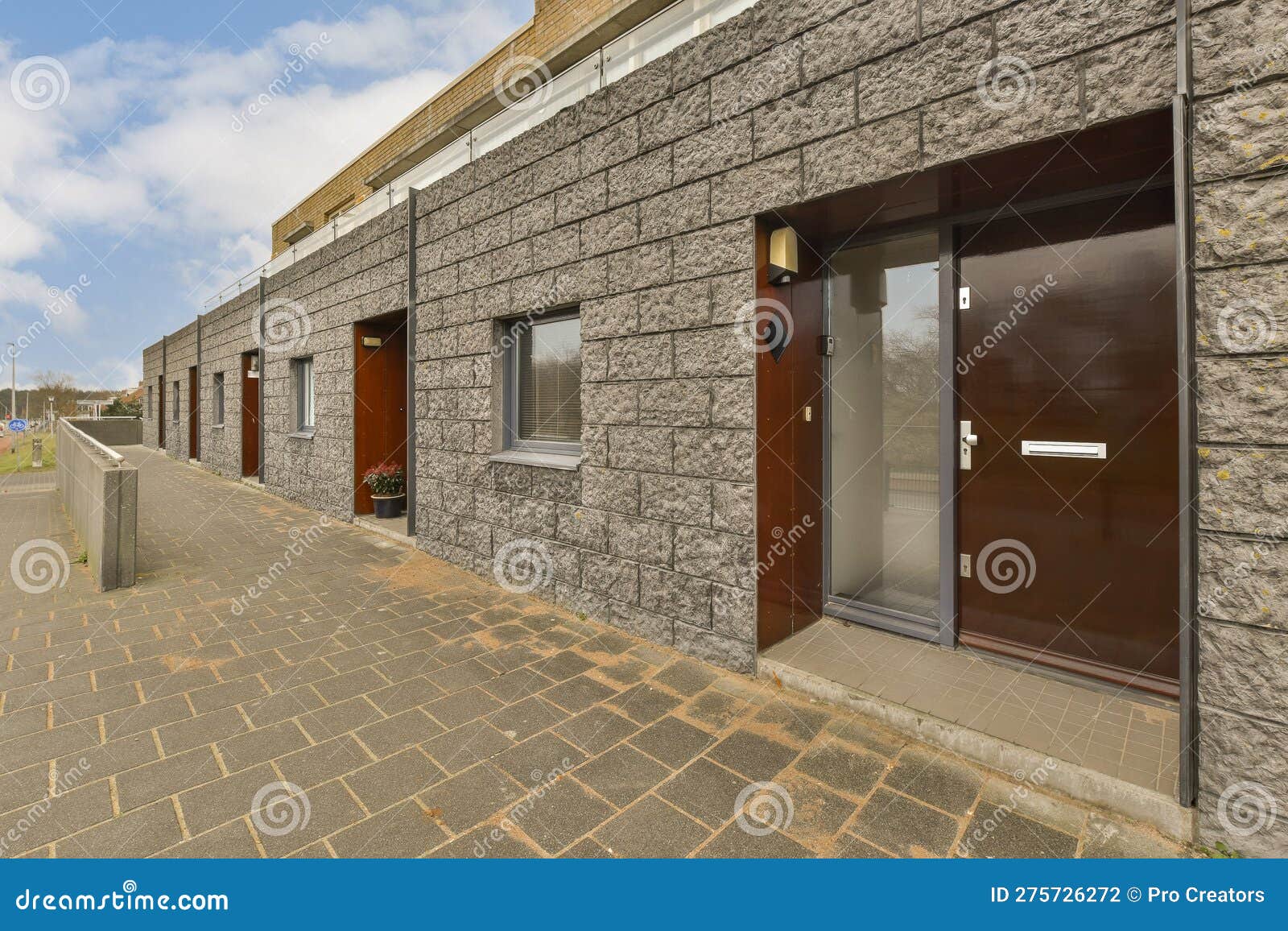 A Row of Doors on the Side of a Building Stock Photo - Image of ...