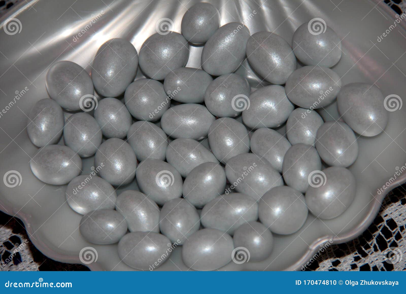 Oval Candies in a Shell on a Lace Tablecloth Stock Photo - Image of ...