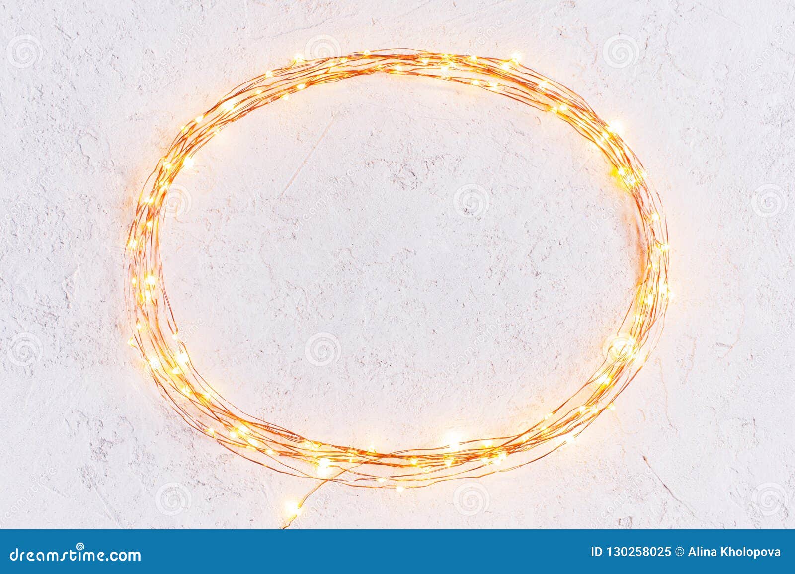 Oval Frame of Christmas Lights on the White Textured Wall Stock Image ...