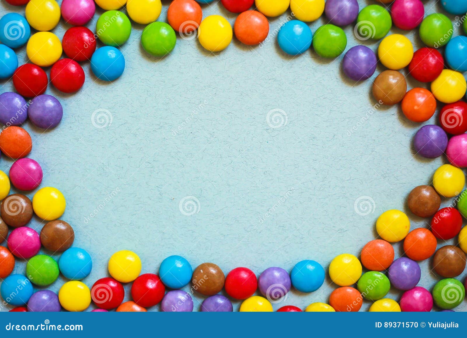 Oval Frame of Multi-colored Candies on Blue Background Stock Photo ...