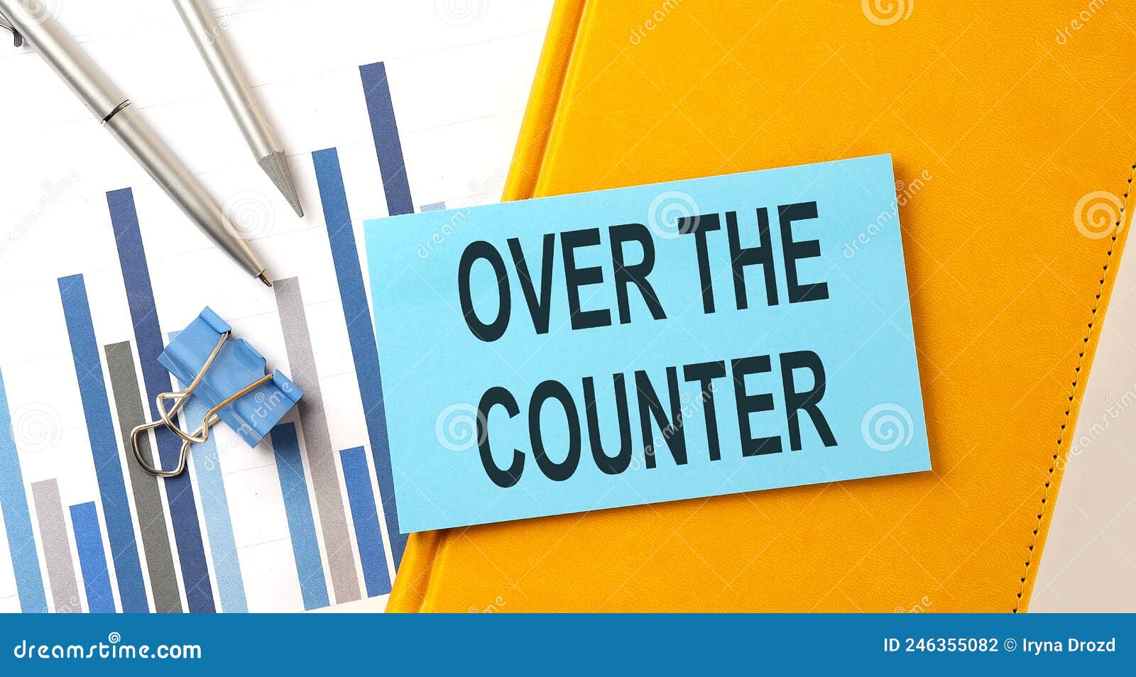OVER the COUNTER Text on Sticker on the Yellow Notebook with Chart and ...