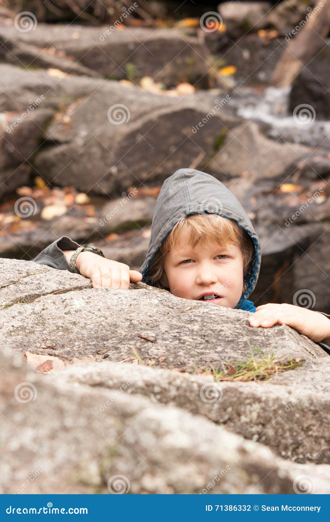 Over the edge. stock photo. Image of peeking, stone, young - 71386332
