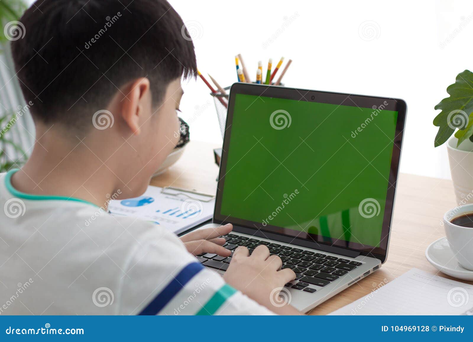 Over the Shoulder Shot of an Asain Boy Typing on a Computer Lapt Stock ...