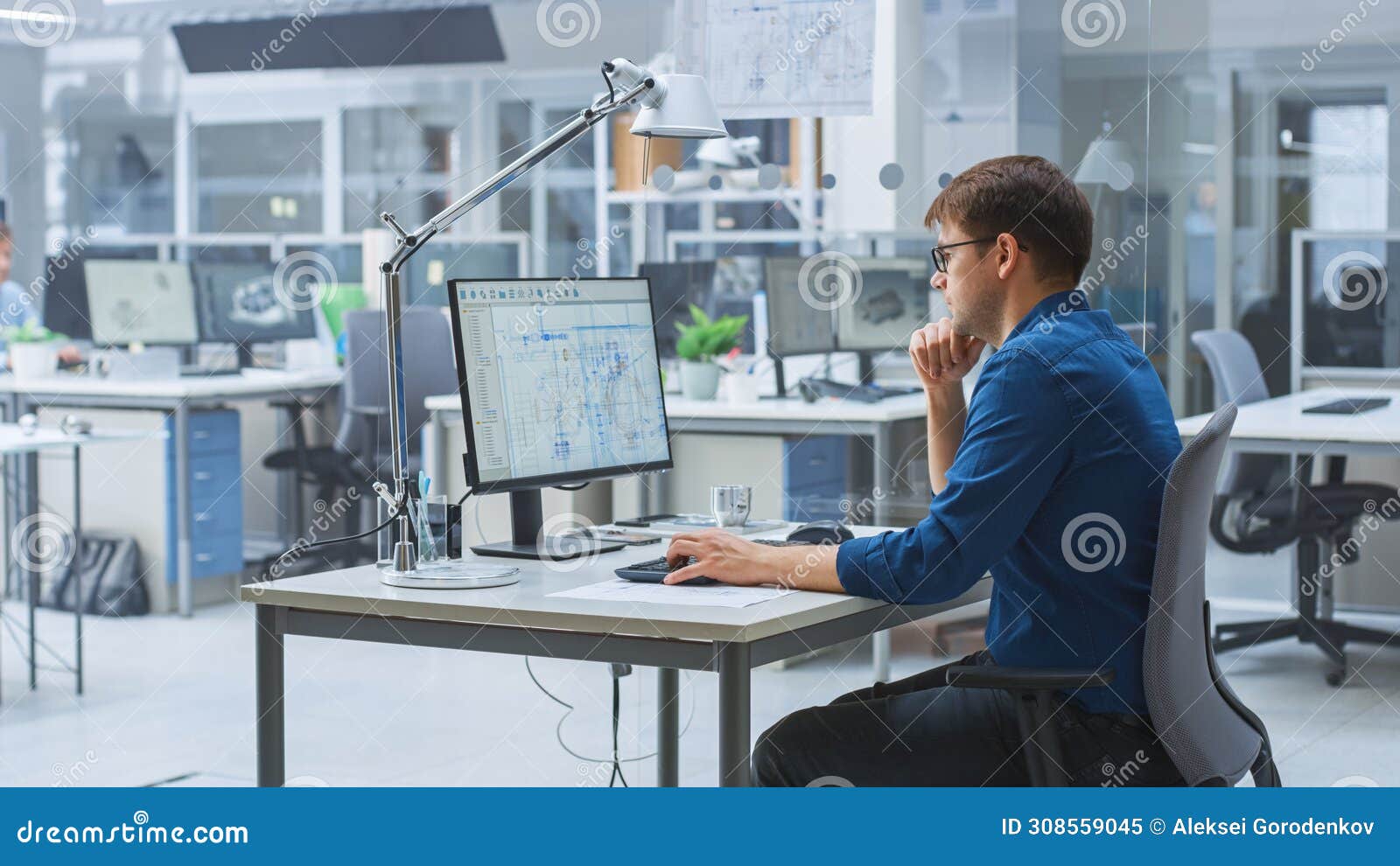 Over the Shoulder Shot of Engineer Working with CAD Software on Desktop ...