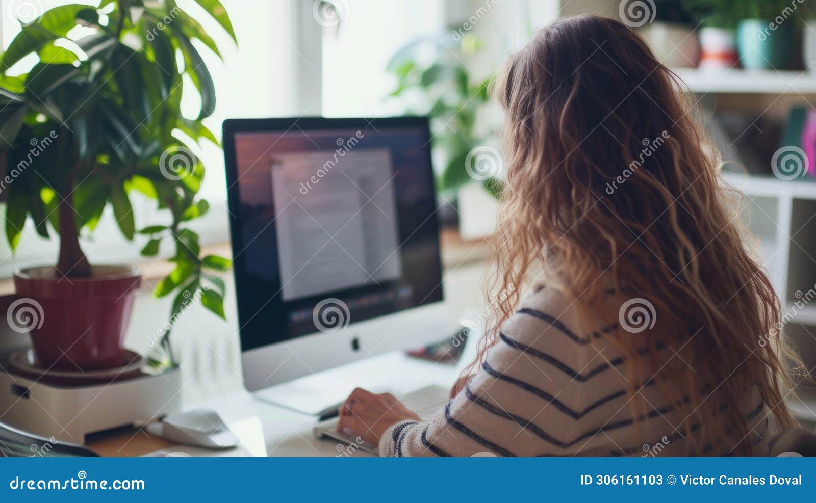 Over Shoulder Shot of a Young Woman Using Computer in Front of a ...
