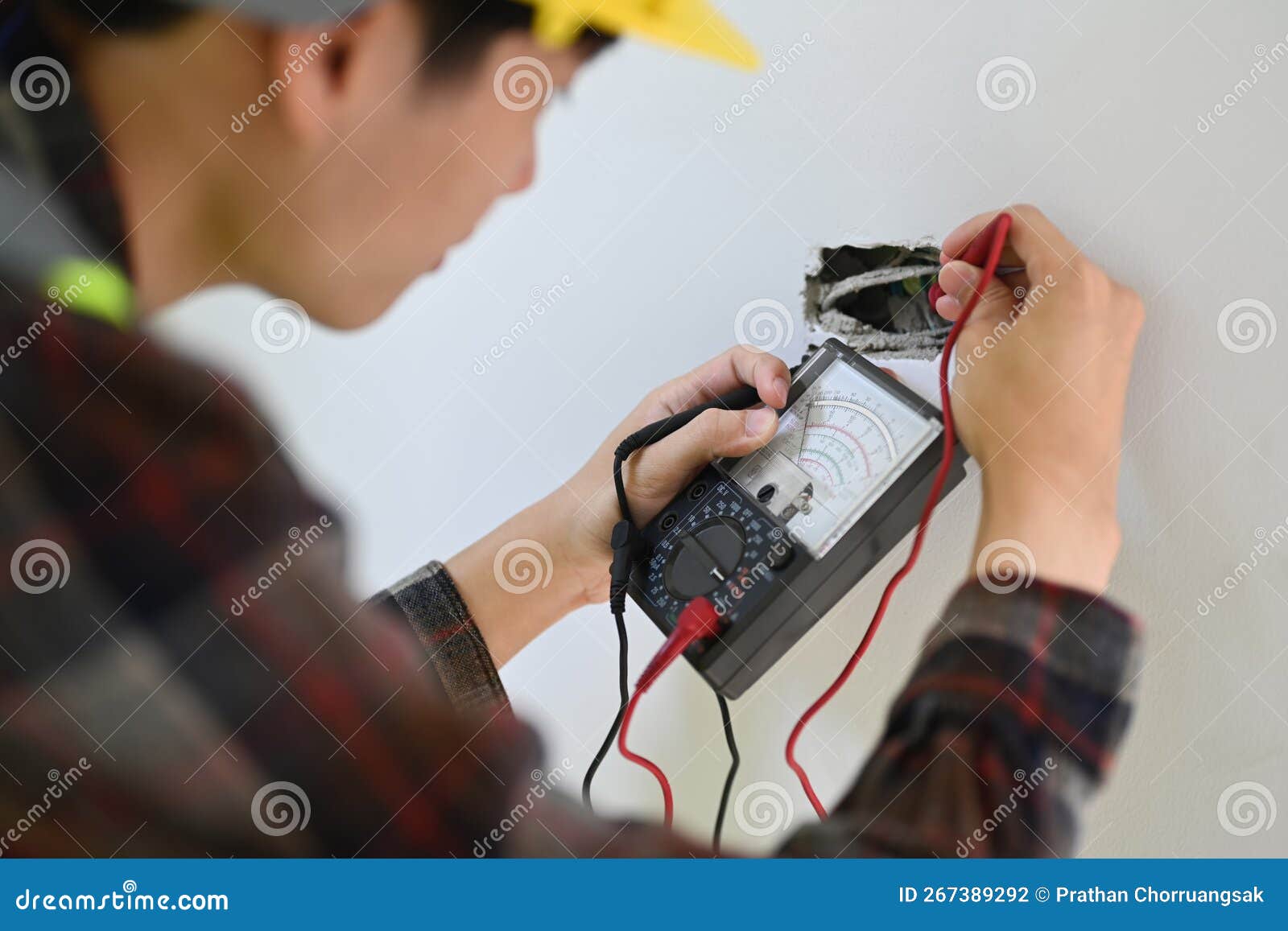 Over Shoulder View of Electrician Installer Using a Multimeter To Test ...