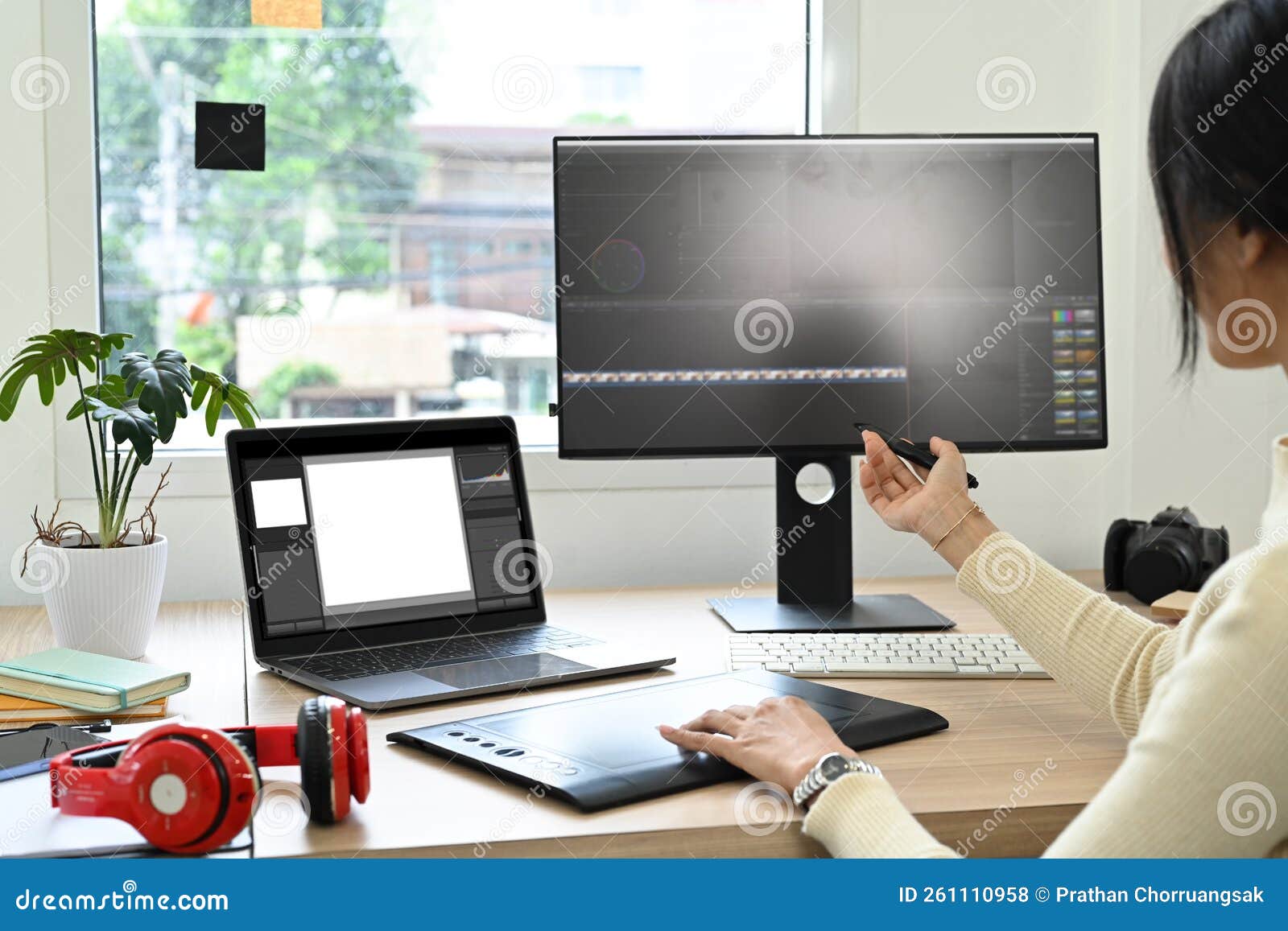 Over Shoulder View of Video Editor Editing Video Footage on Personal ...